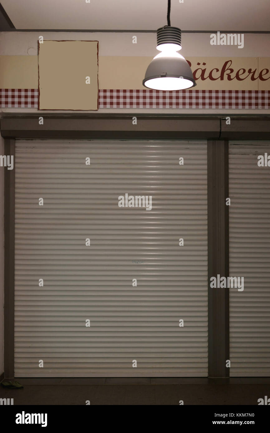 A closed bakery with lowered window blinds Stock Photo - Alamy