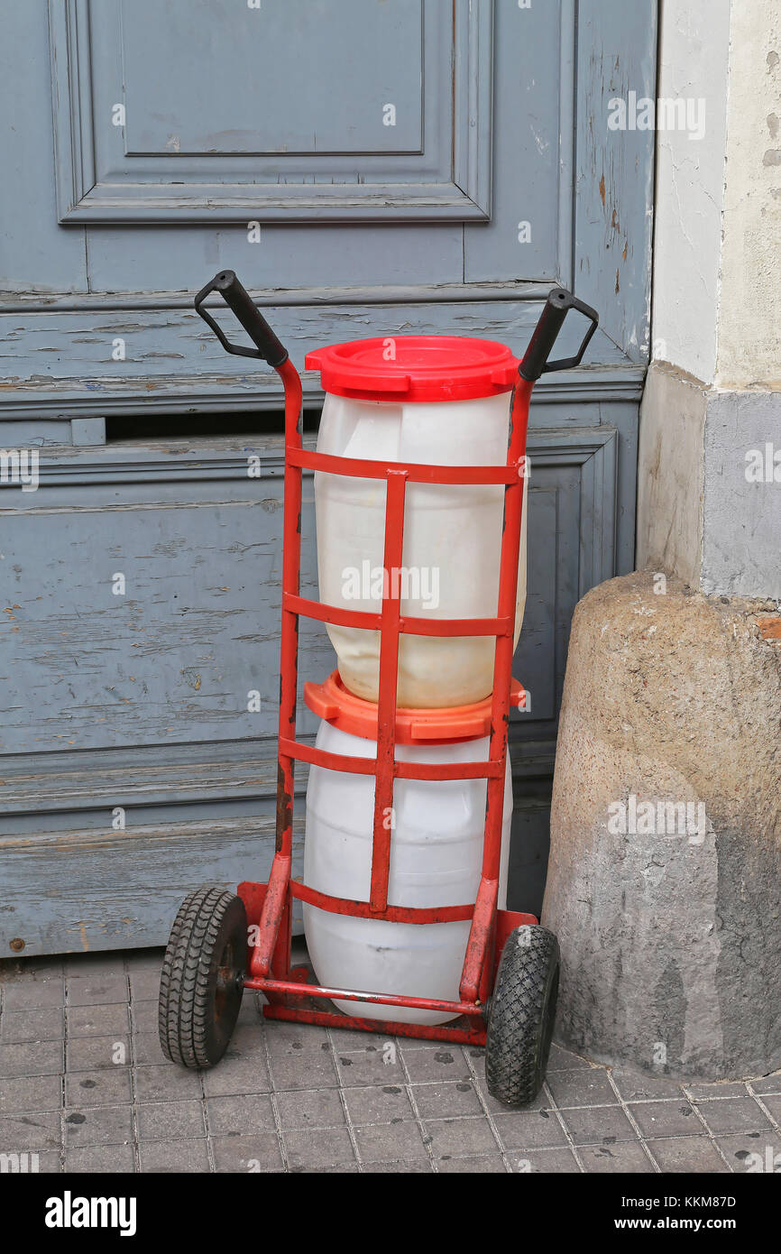 Two Plastic Barrels at Dolly Transport Delivery Stock Photo - Alamy