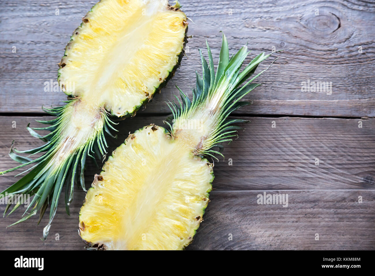 Pineapple on the wooden background: cross section Stock Photo - Alamy