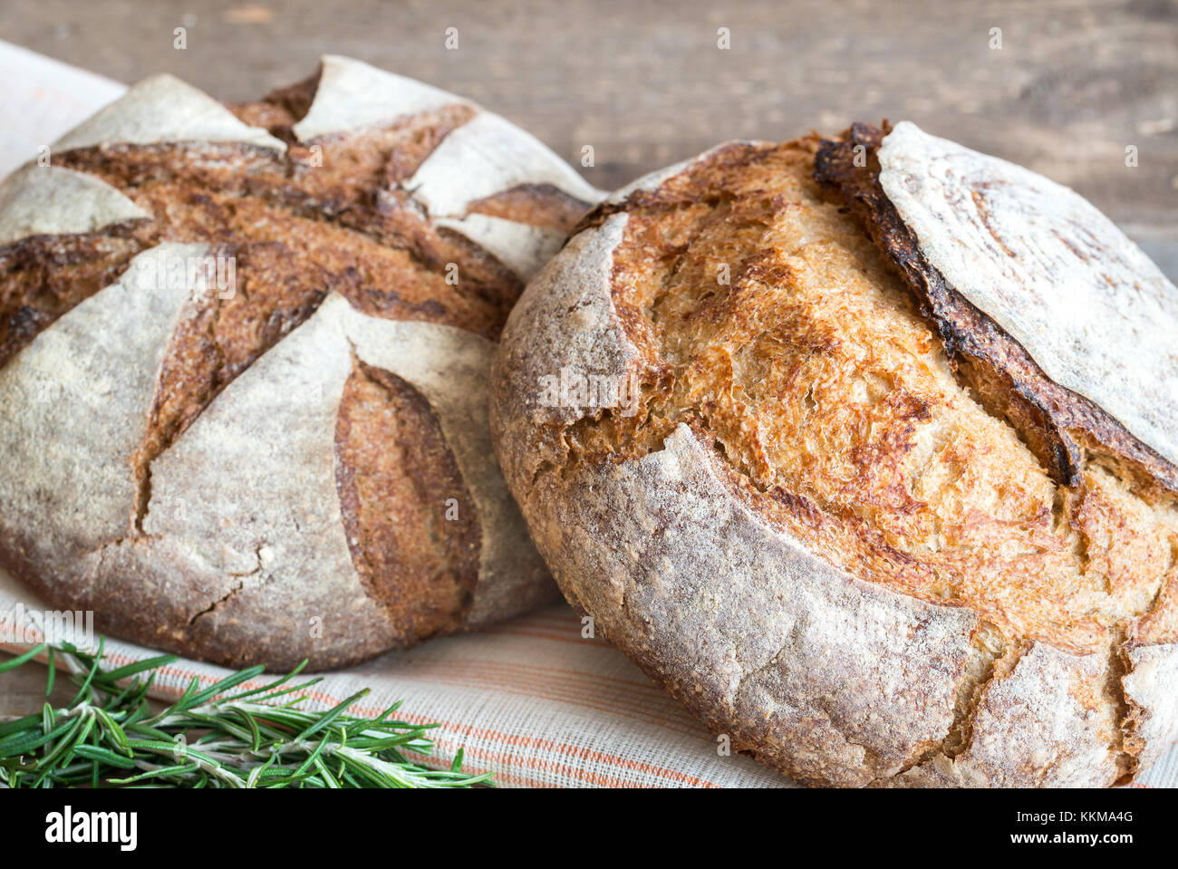 Two loaves of bread on the old-fashioned background Stock Photo - Alamy