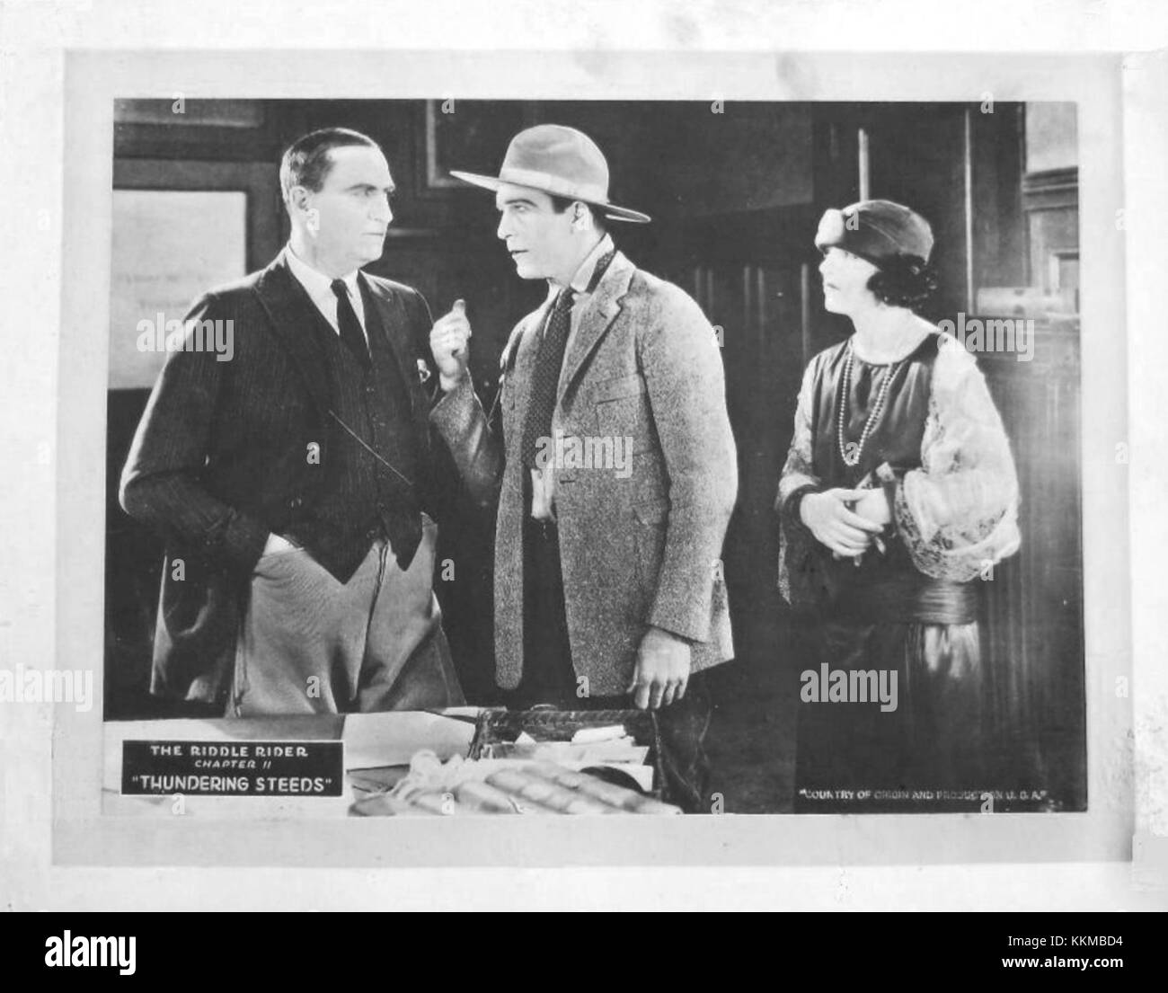 This lobby card features an image from the movie 'Riddle Rider.' It ...