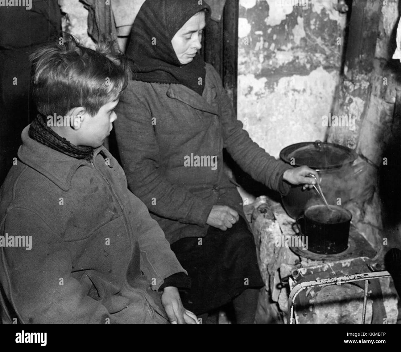 This photograph captures a moment in 1947 Poland, where a woman is ...