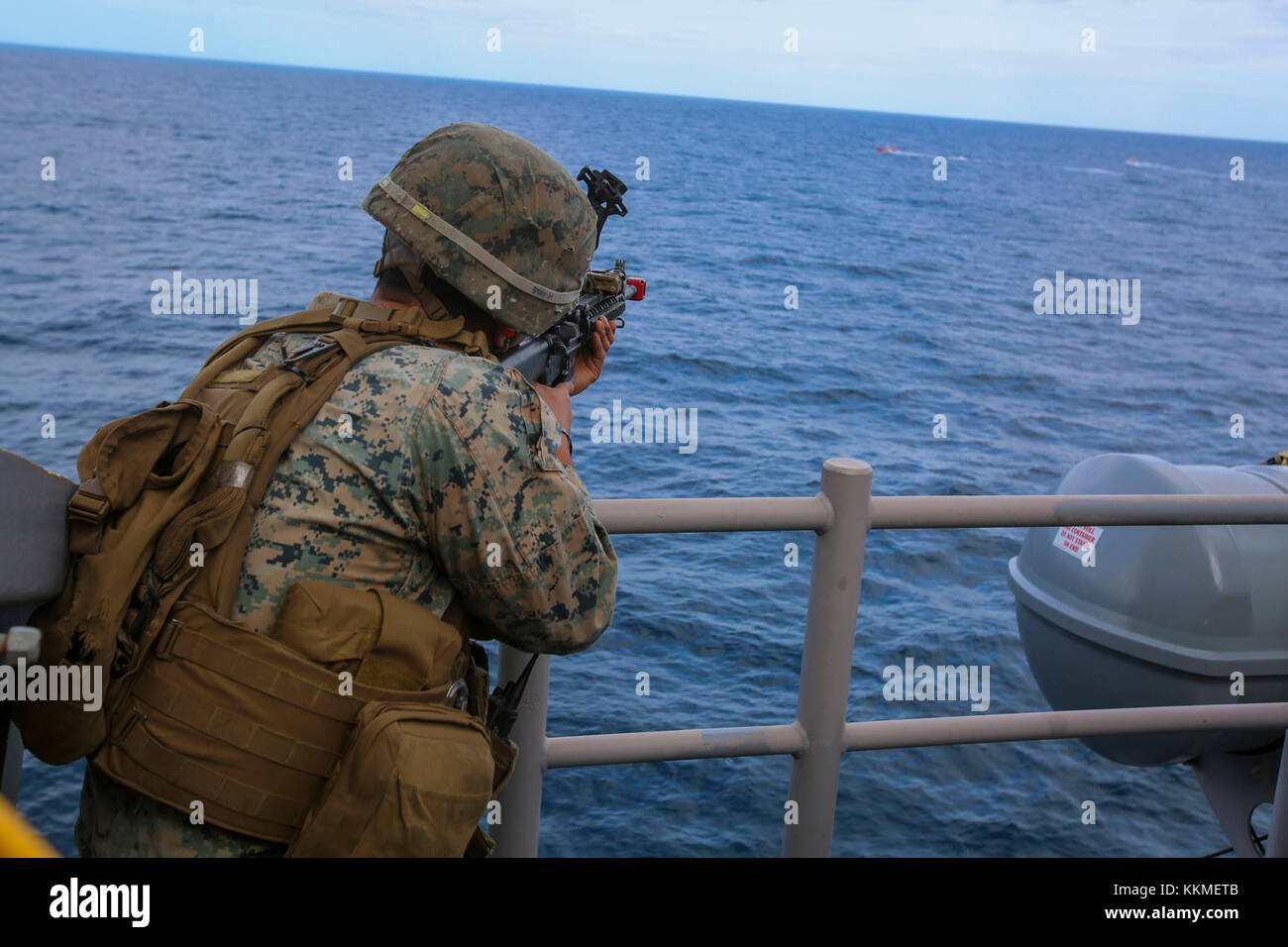 A U.S. Marine aims his rifle at a threat during a Defense of the ...