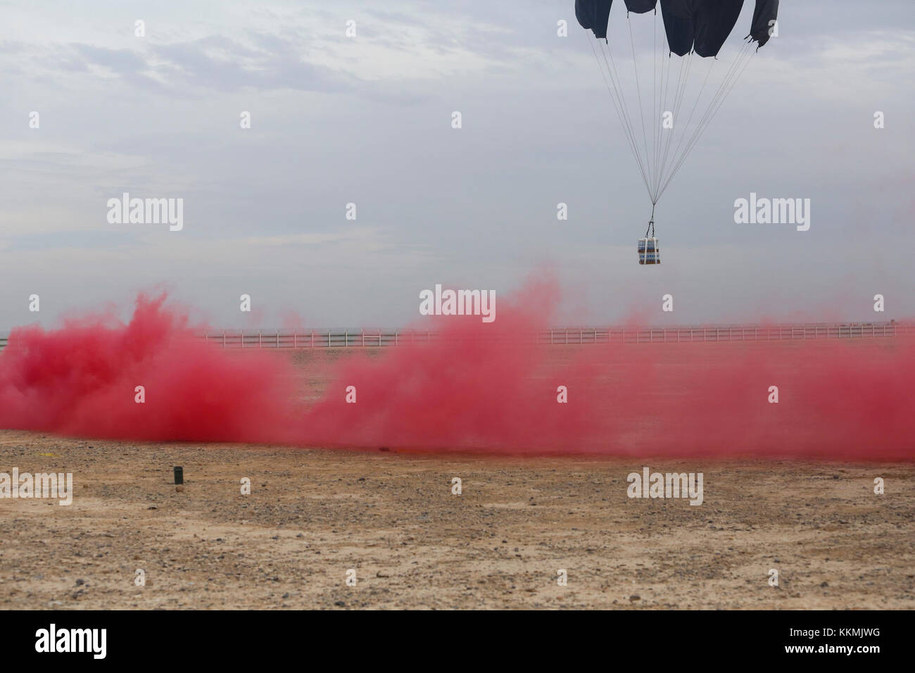 Water lands at Camp Shorabak, Afghanistan following an airdrop from an ...