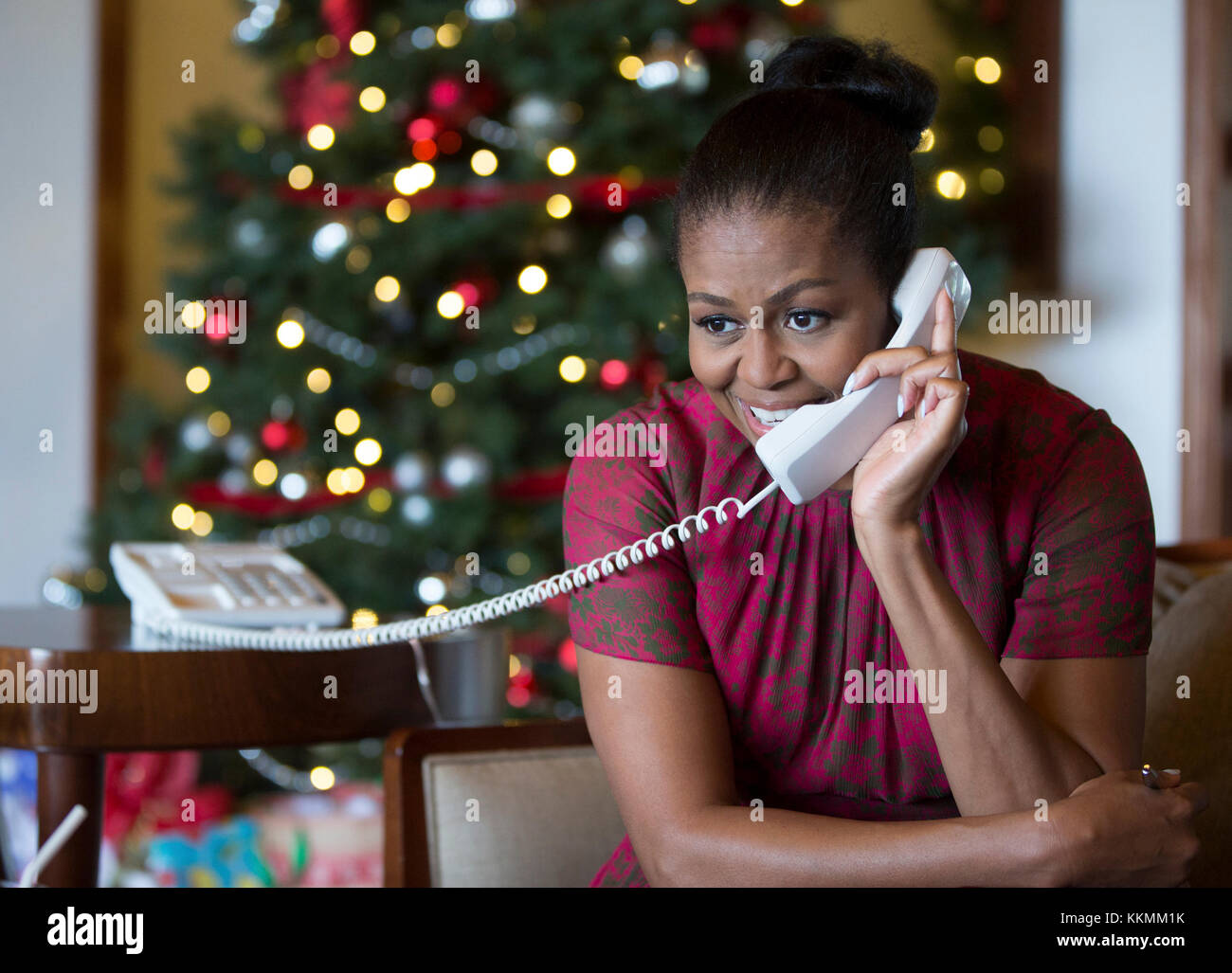 First Lady Michelle Obama reacts while talking on the phone to children ...