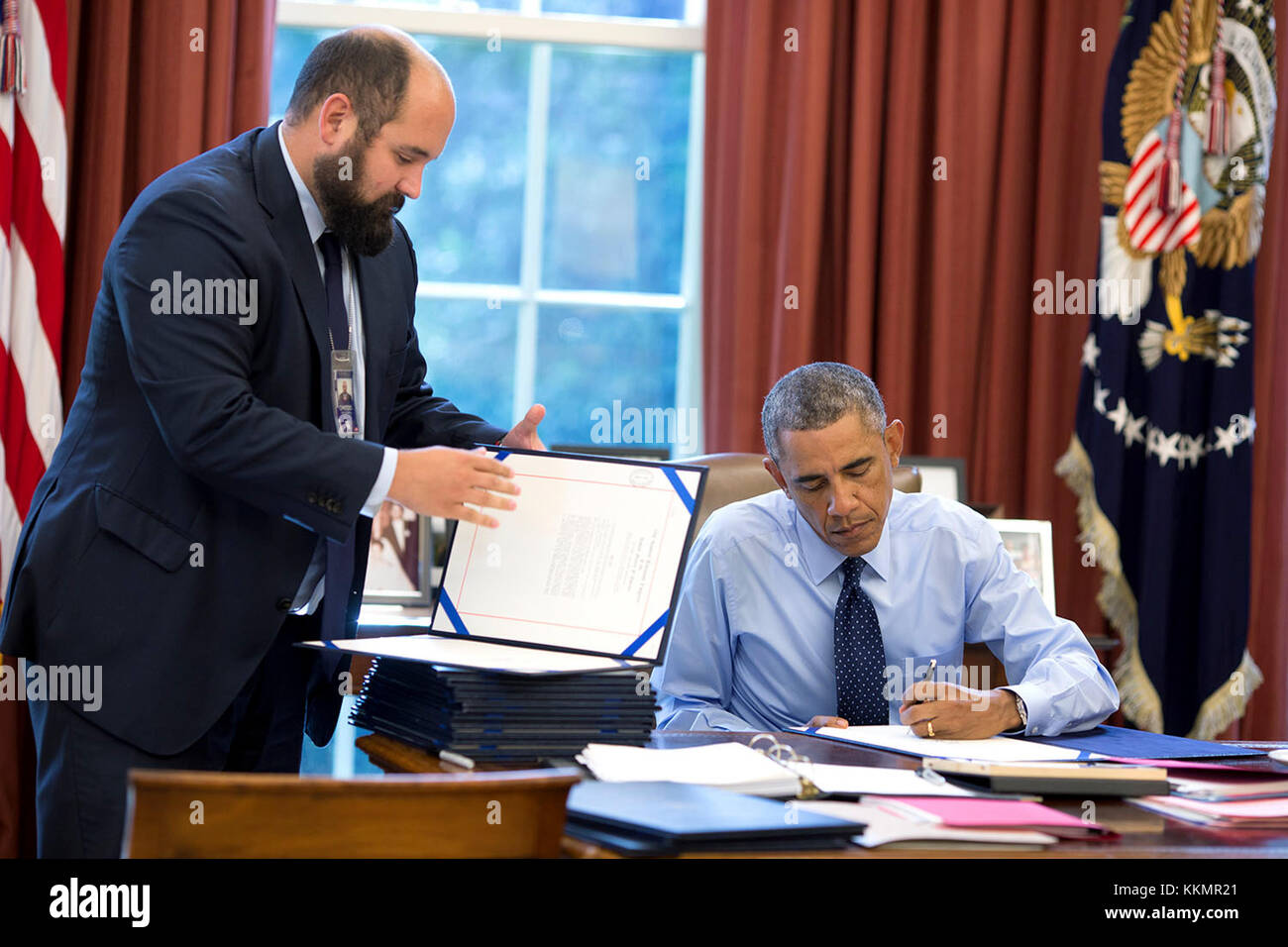 President Barack Obama, assisted by Deputy Staff Secretary Ted Chiodo ...