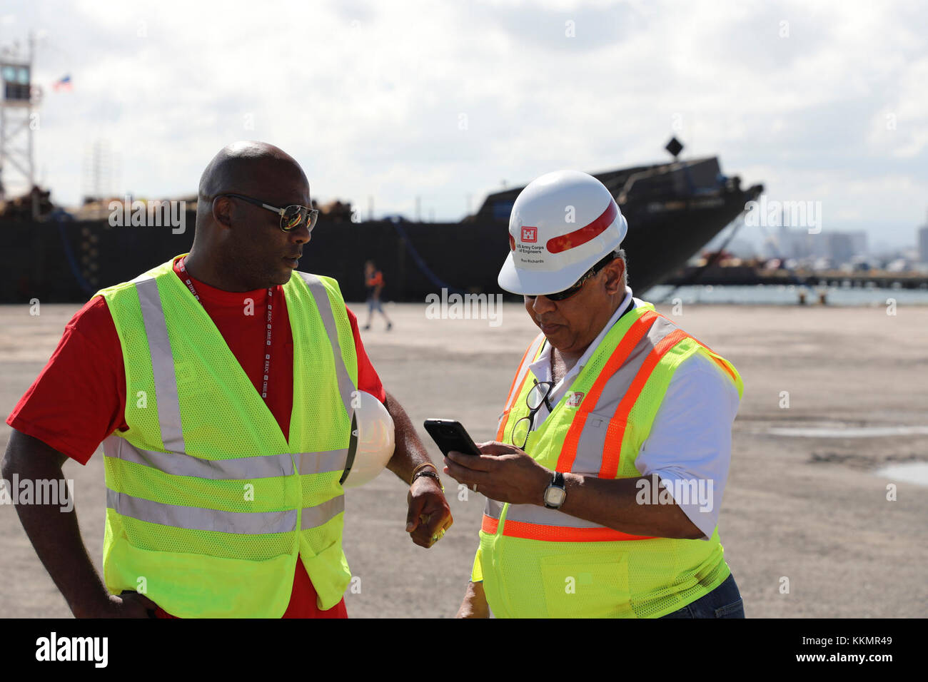 Two U.S. Army Corps of Engineers employees discuss unloading the 157 ...