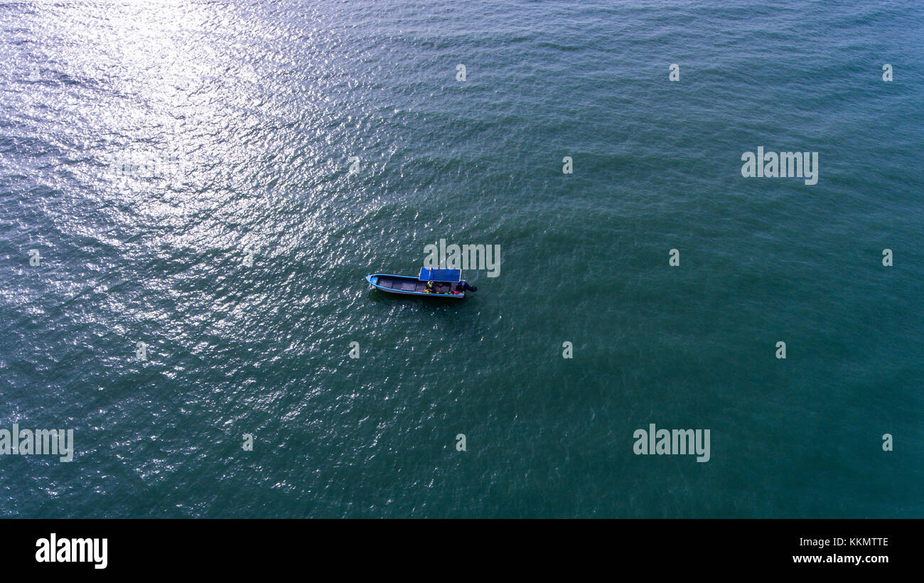 A Small Boat In The Vast Sea Stock Photo - Alamy