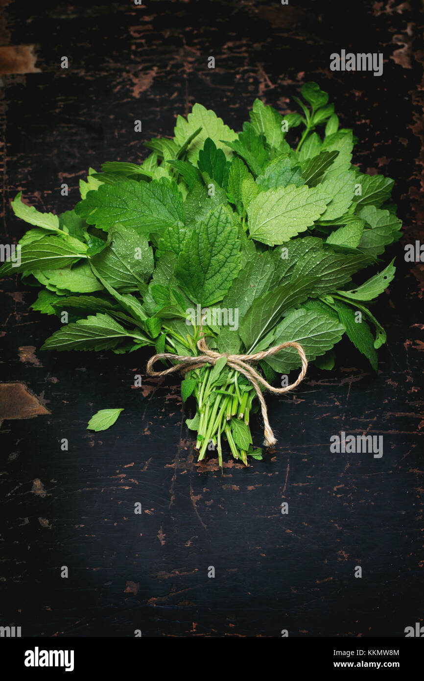 Bunch of fresh mint over black wooden table Stock Photo - Alamy