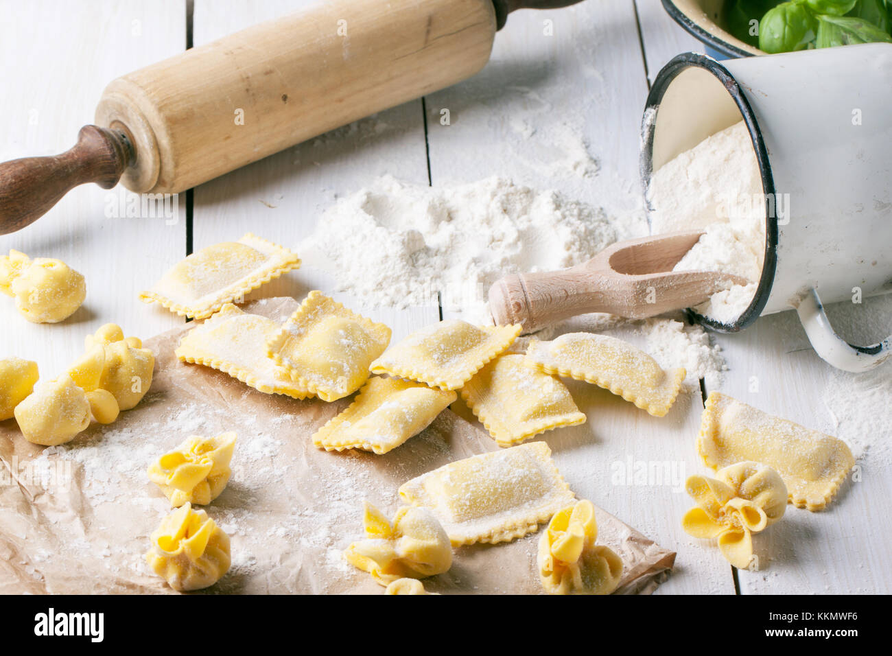 Close up of homemade pasta ravioli and perle on wooden table with metal ...