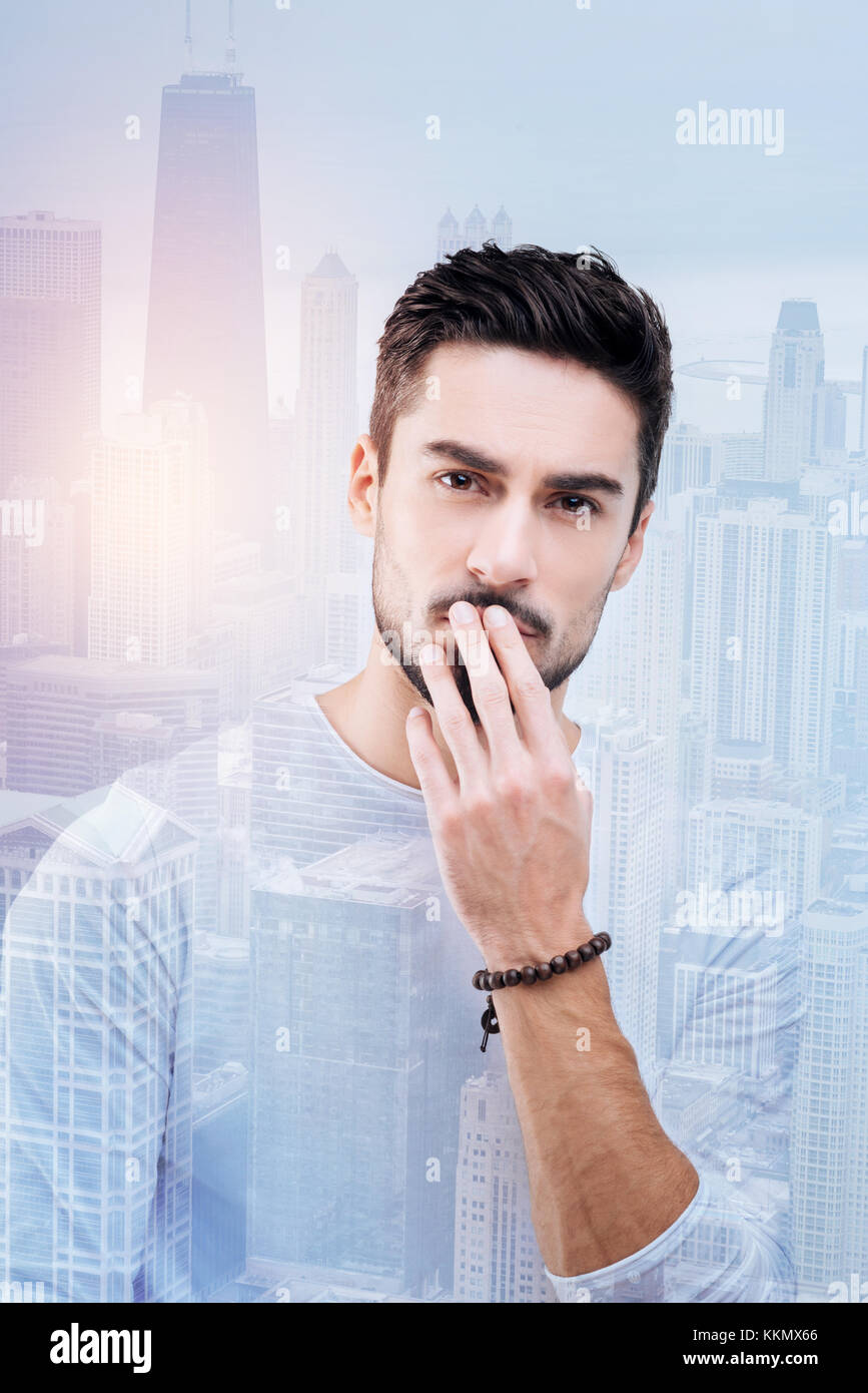Attractive man covering his mouth Stock Photo - Alamy