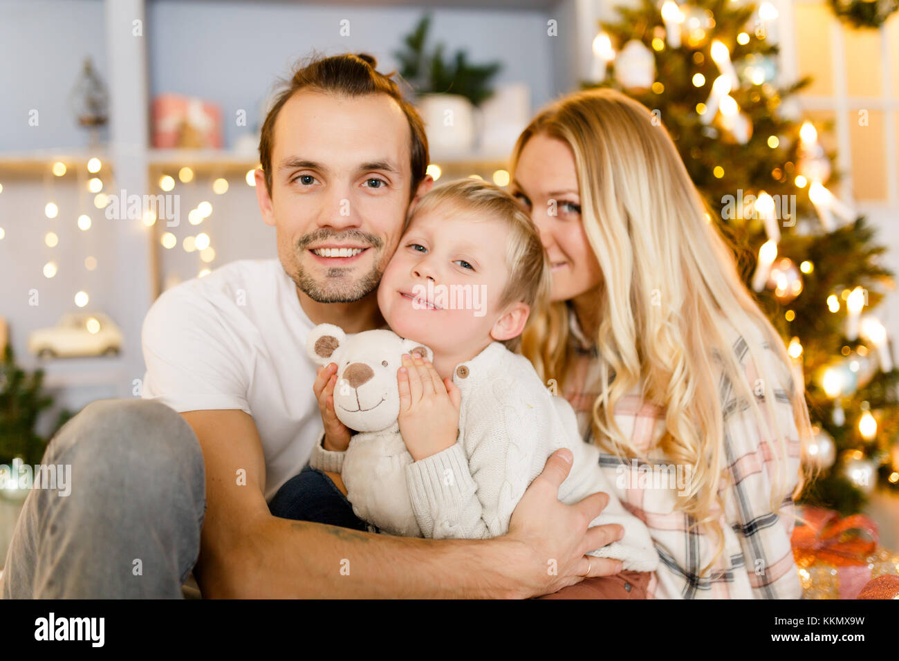 Beautiful family in Christmas interior Stock Photo - Alamy