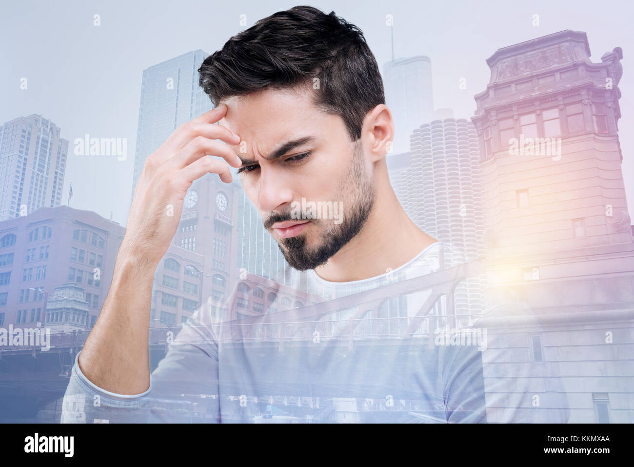 Disturbed young man wrinkling forehead Stock Photo - Alamy