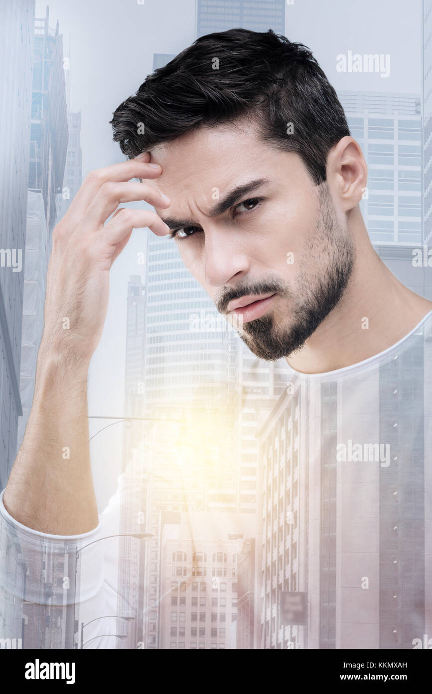 Angry model having strong headache Stock Photo - Alamy
