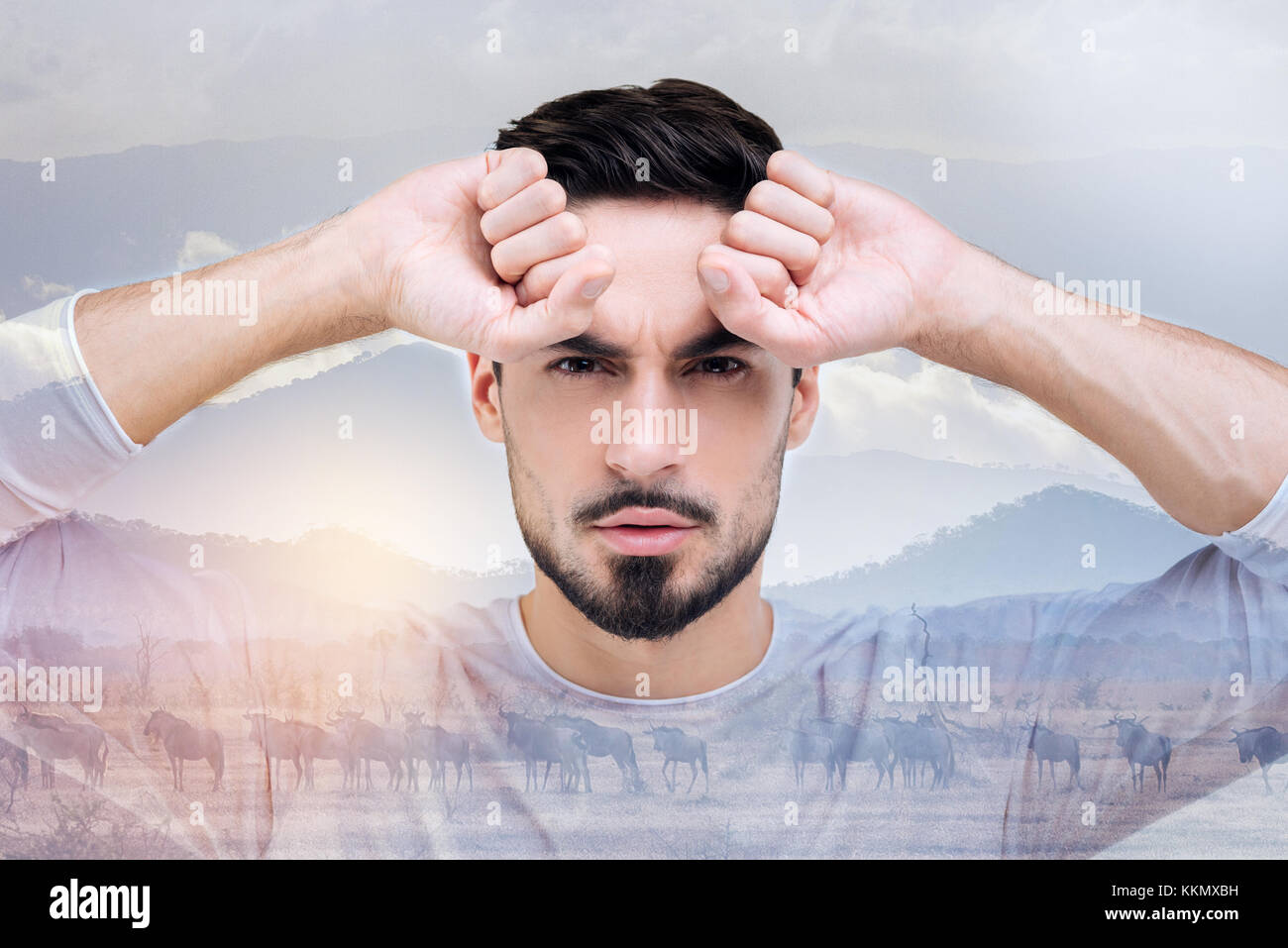 Concentrated man looking straight at camera Stock Photo - Alamy