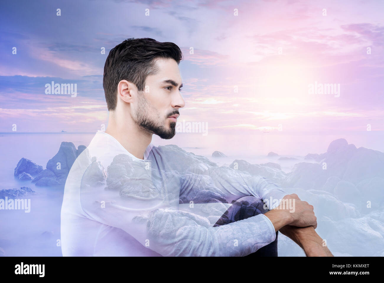 Calm brunette male person sitting in semi position Stock Photo - Alamy