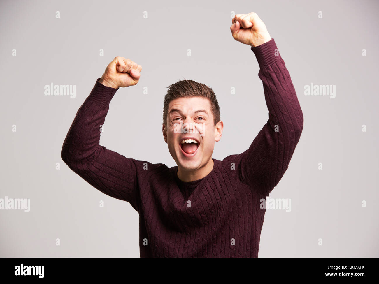 Portrait of a celebrating young white man punching the air Stock Photo ...
