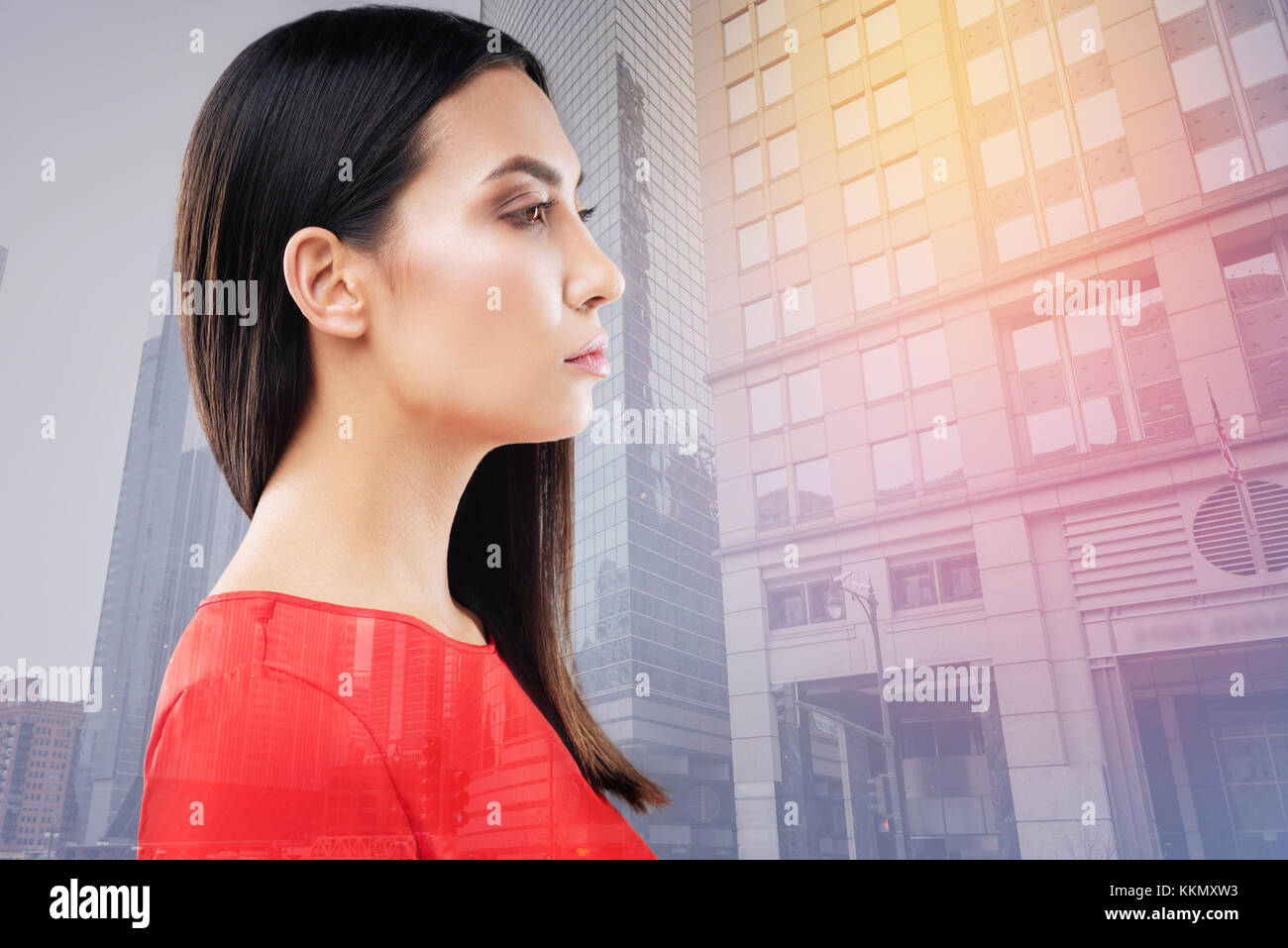 Serious female person standing against urban surrounding Stock Photo ...