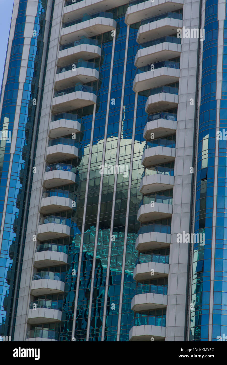 There is a building reflected on the surface of another building. The ...