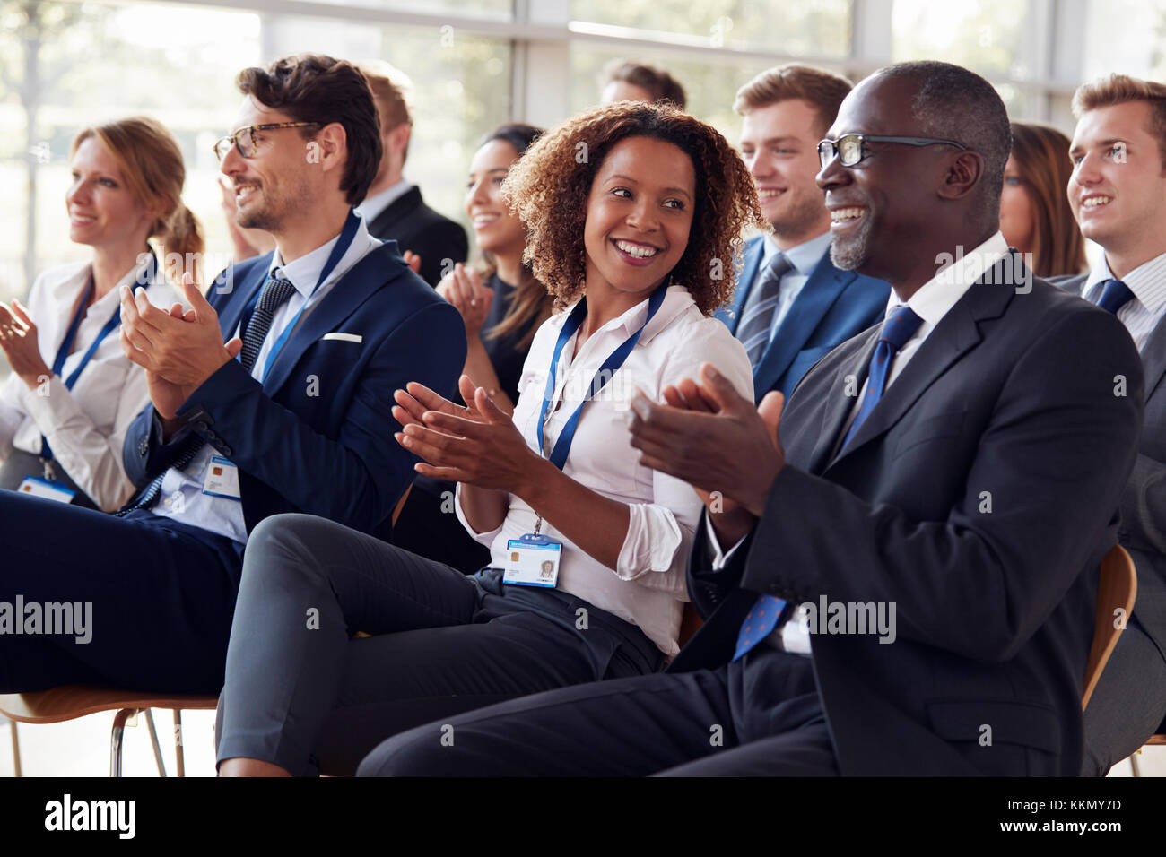 Smiling audience applauding at a business seminar Stock Photo - Alamy