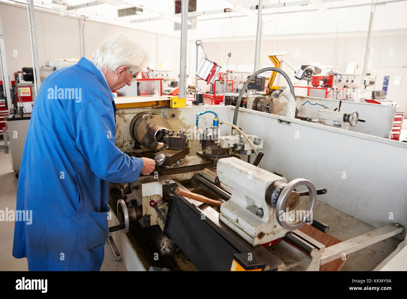 Senior engineer working in a factory, back view Stock Photo - Alamy