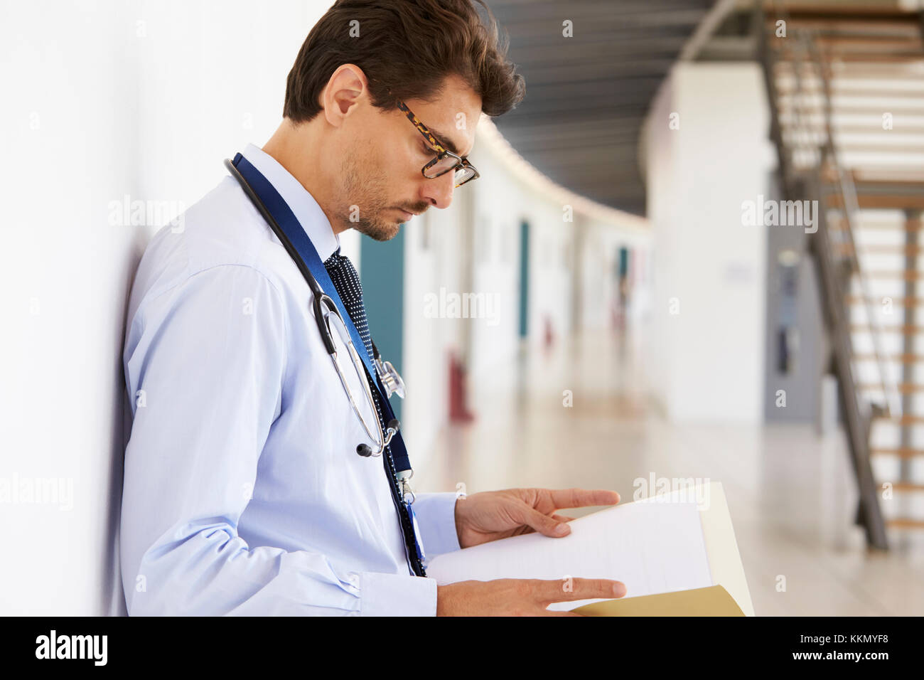 Portrait of young male doctor with stethoscope and notes Stock Photo ...