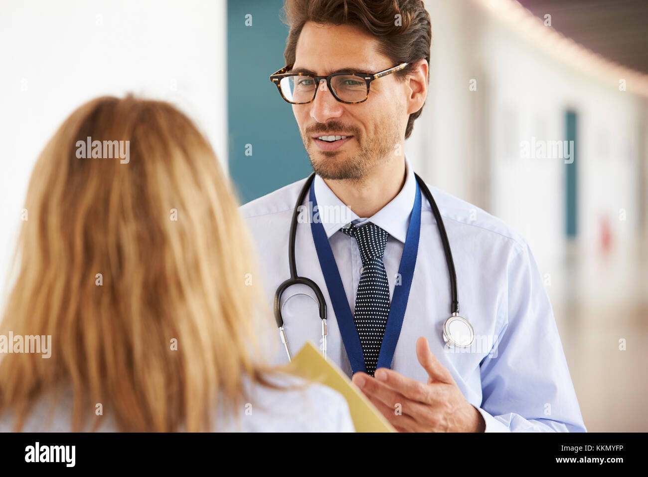 Young male and female doctors talking, close up Stock Photo - Alamy
