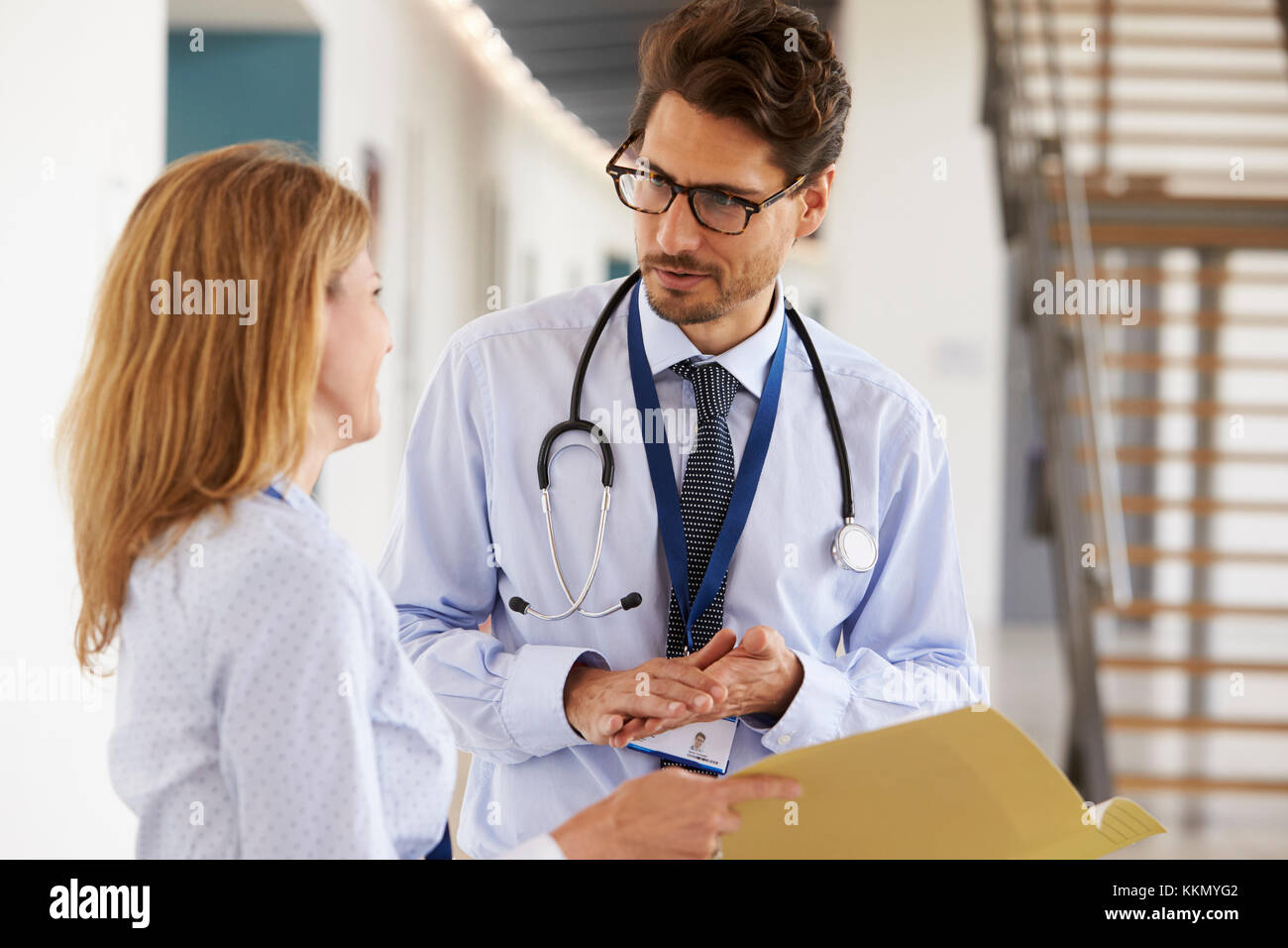 Young male and female doctors consulting each other Stock Photo - Alamy