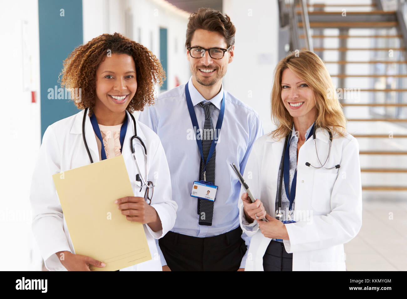 Portrait of three male and female doctors, looking to camera Stock ...