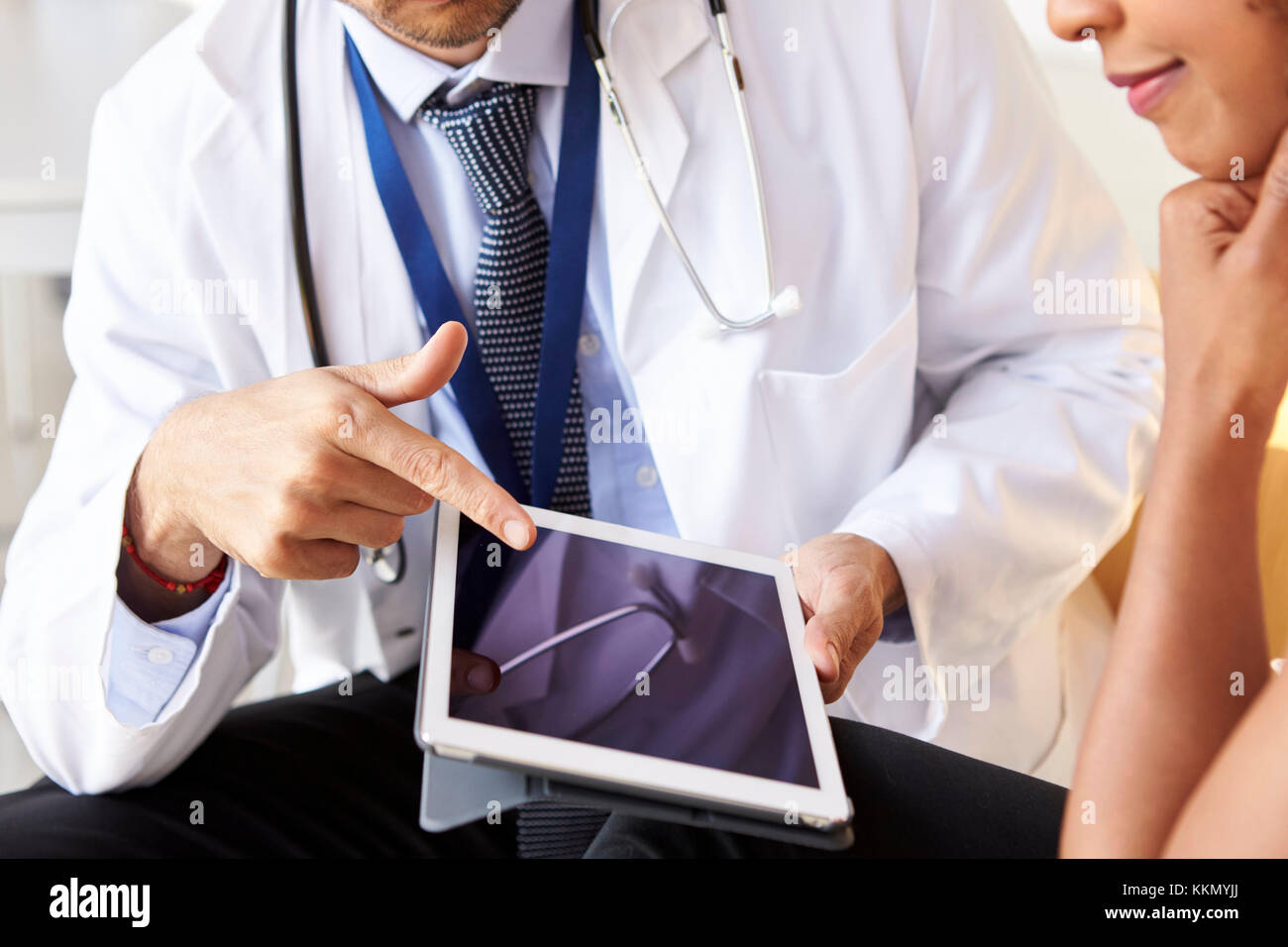 Two senior doctors using tablet computer, mid section Stock Photo - Alamy