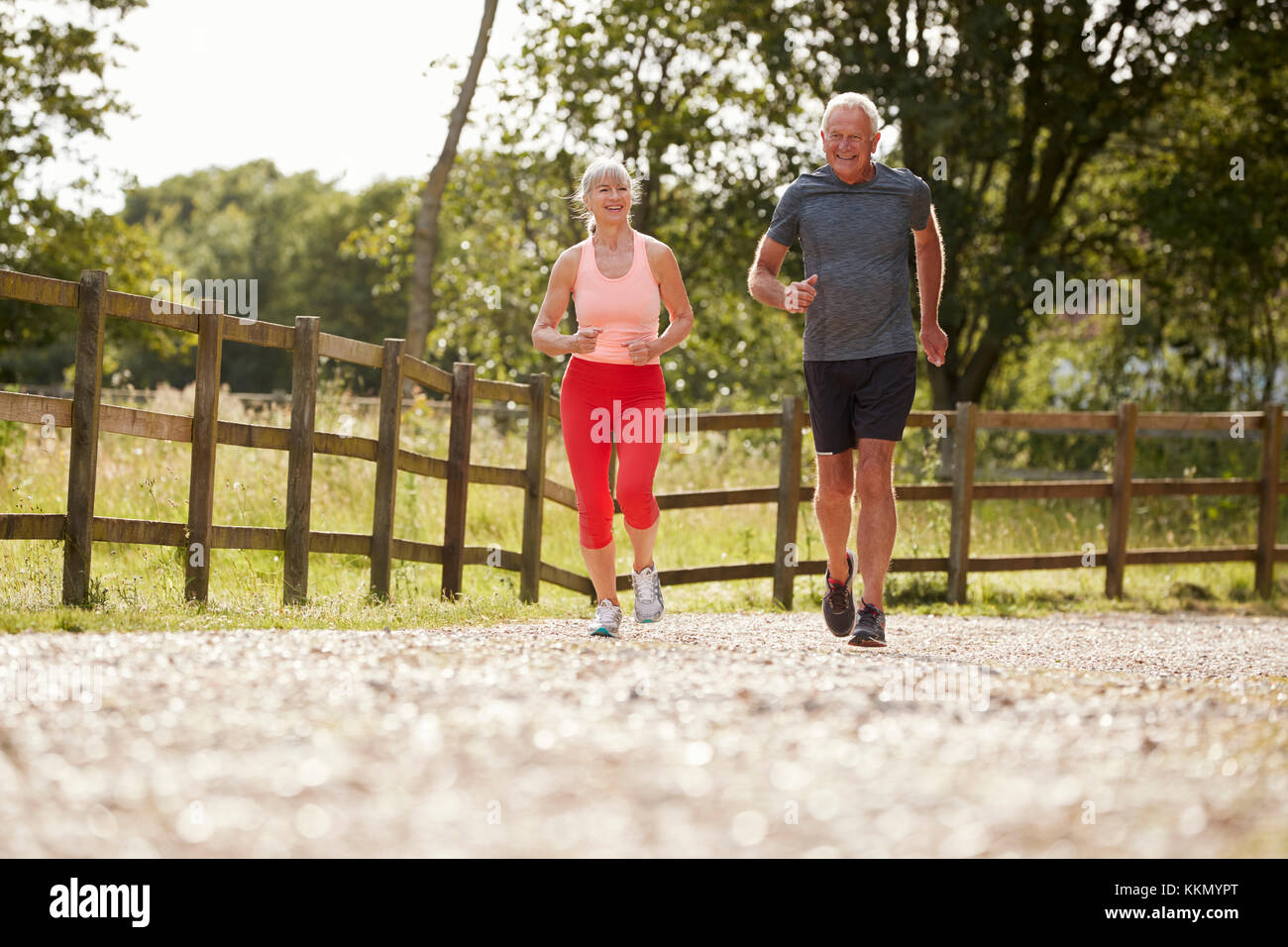 Healthy Senior Couple Enjoying Run Through Countryside Together Stock ...