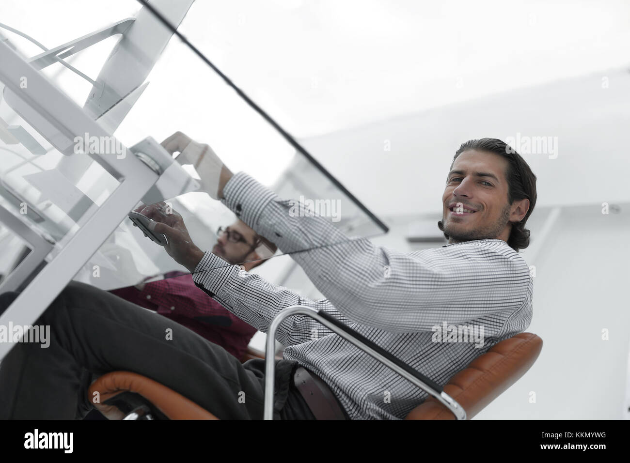 bottom view.businessman sitting behind a Desk Stock Photo - Alamy