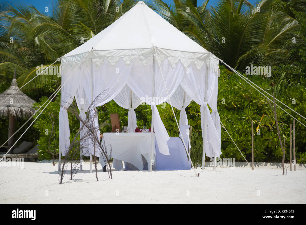 Dining table in the beach in Maldives. The table is right on the shore ...