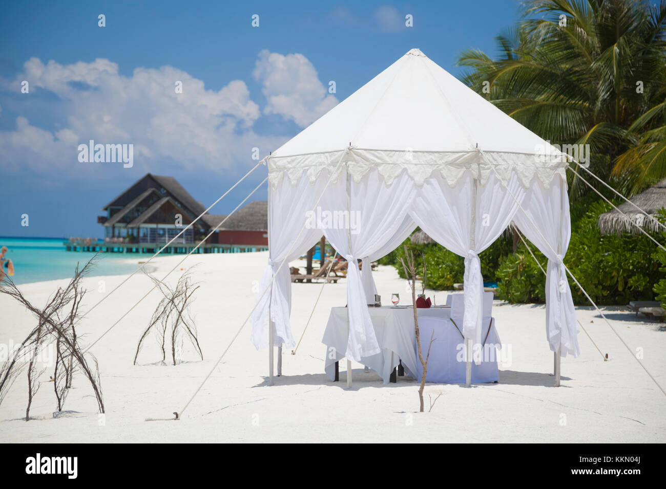Dining table in the beach in Maldives. The table is right on the shore ...
