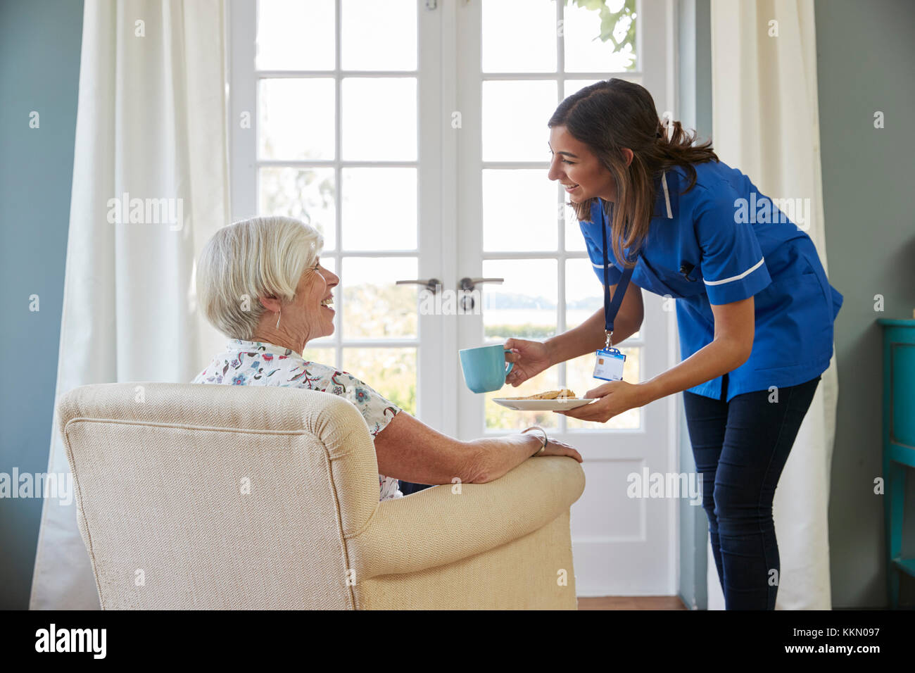 Smiling nurse holding tea hi-res stock photography and images - Alamy