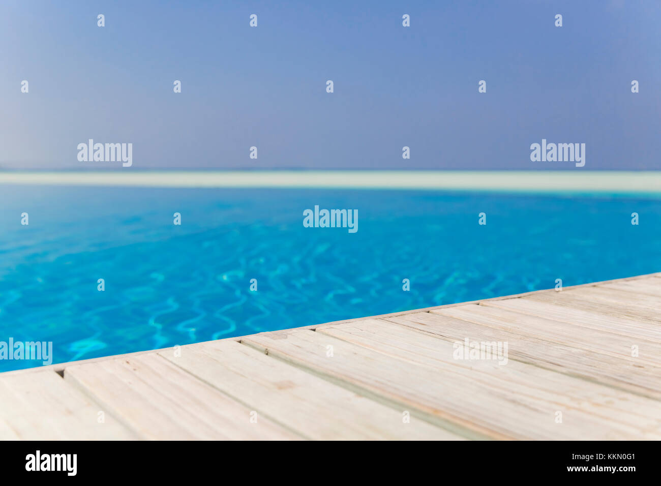 Beautiful shot from edge of a swimming pool with beach at background ...