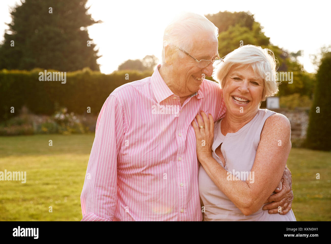 Senior couple in garden smiling to camera, close up Stock Photo - Alamy