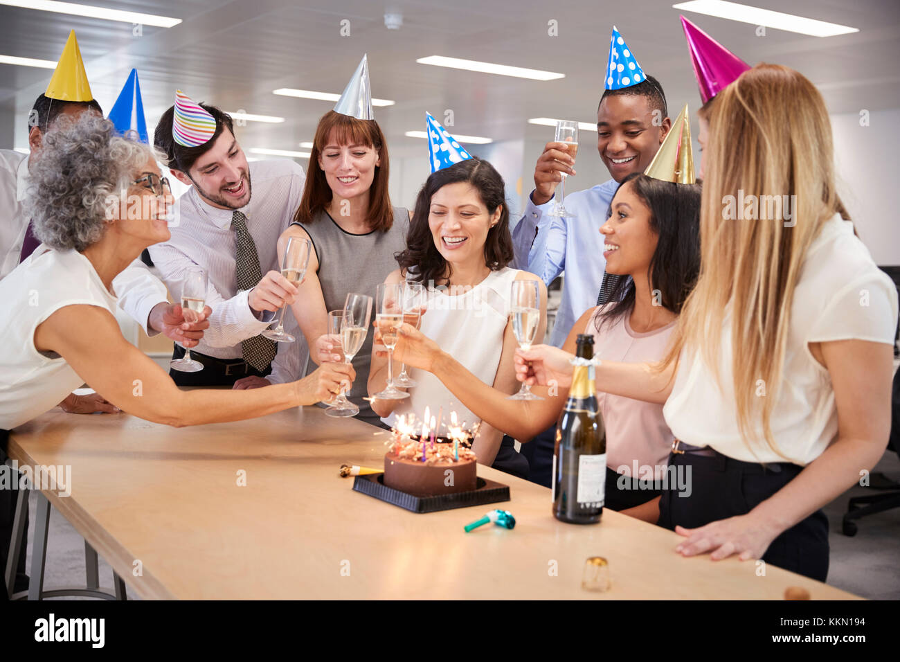 Colleagues celebrating a birthday in the office make a toast Stock ...