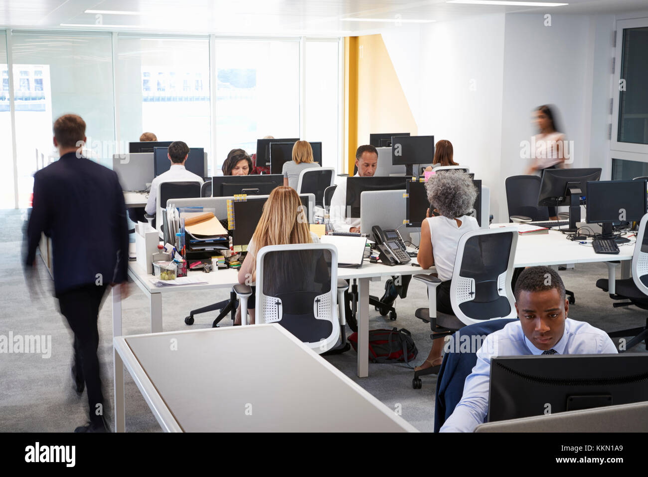 Man walking through a busy open plan office Stock Photo - Alamy Man walking through a busy open plan office Stock Photo - Alamy