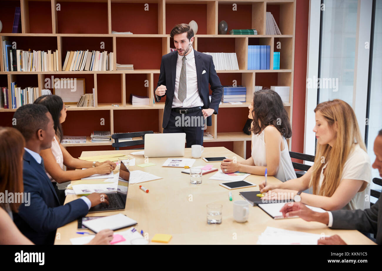 Young male manager standing at a business boardroom meeting Stock Photo ...