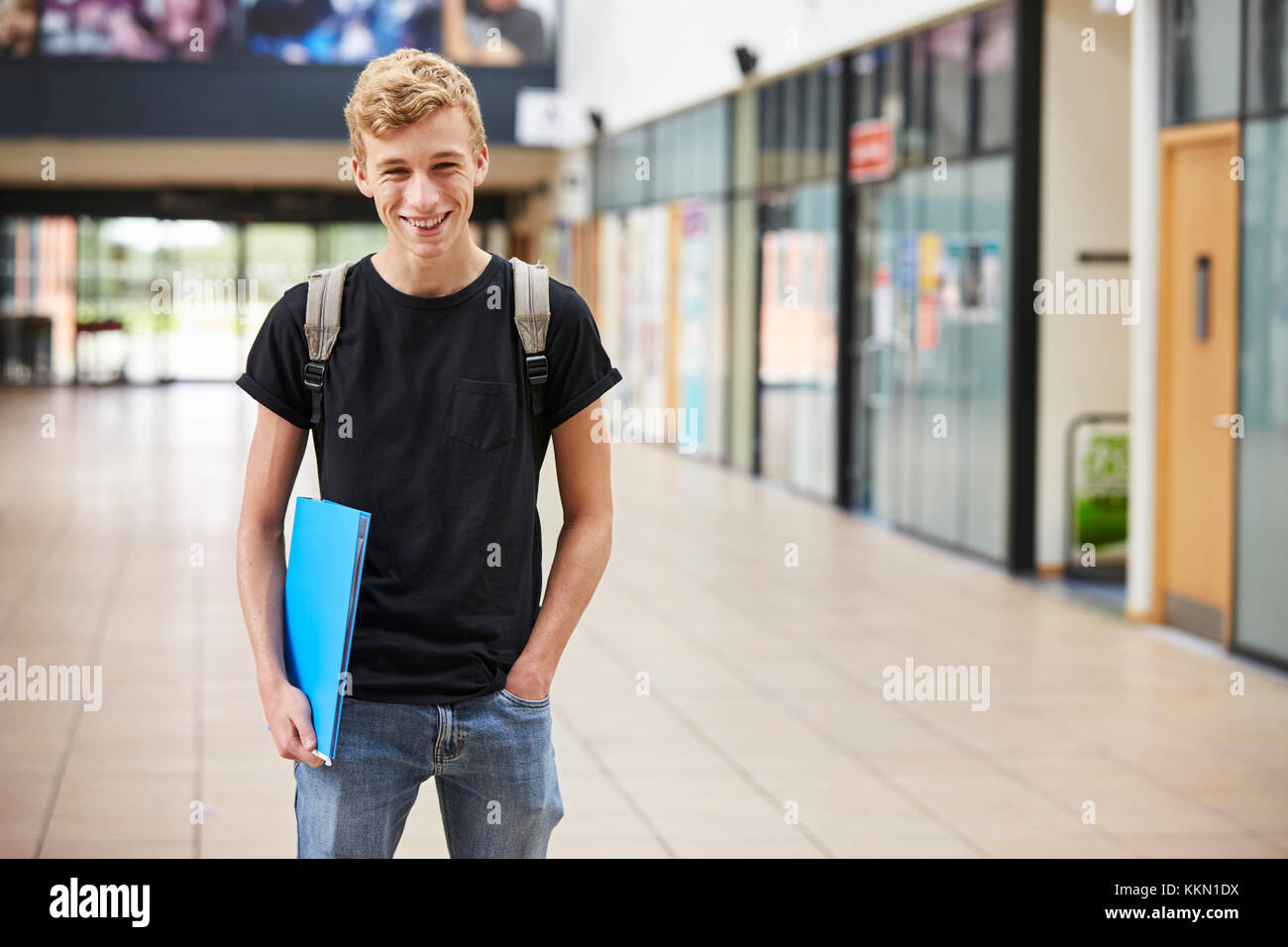 Portrait Of Male Student Standing In College Building Stock Photo - Alamy