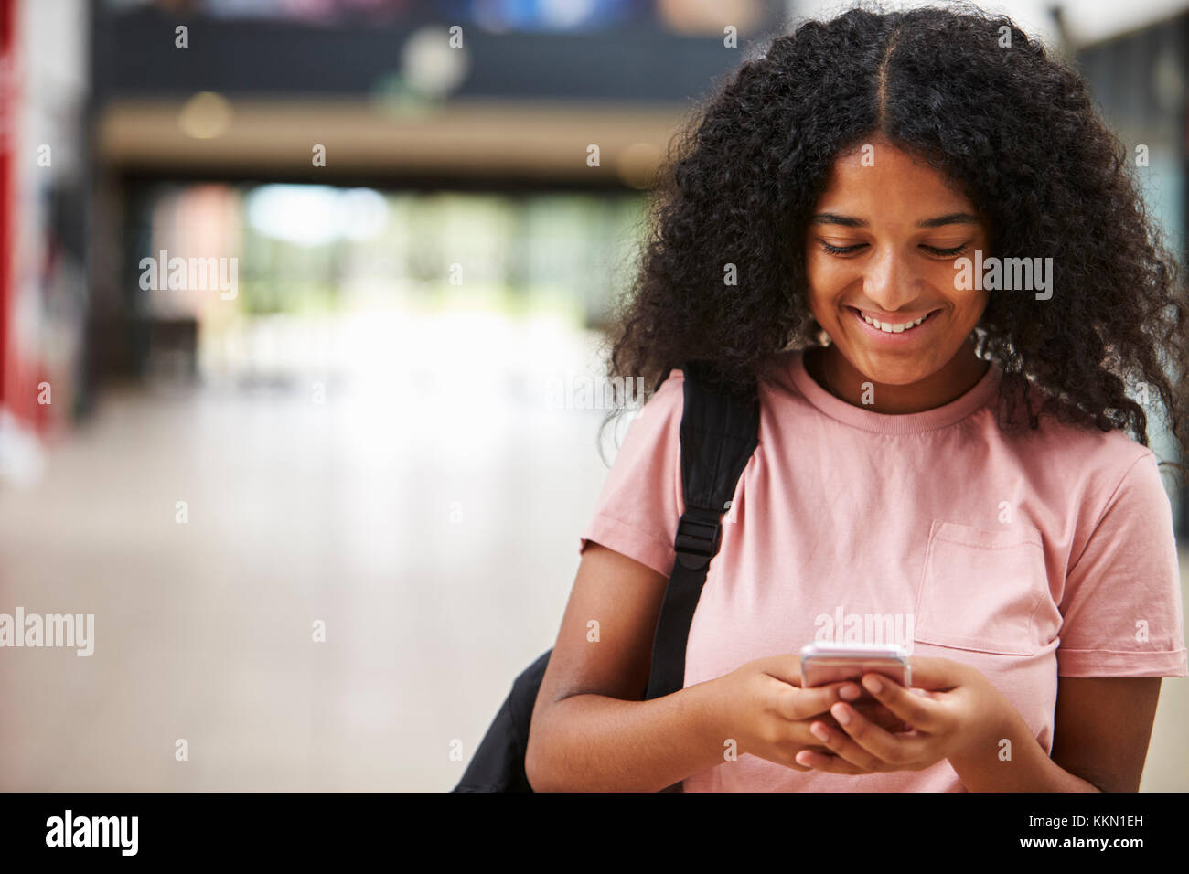Female College Student Reading Text Message On Mobile Phone Stock Photo ...