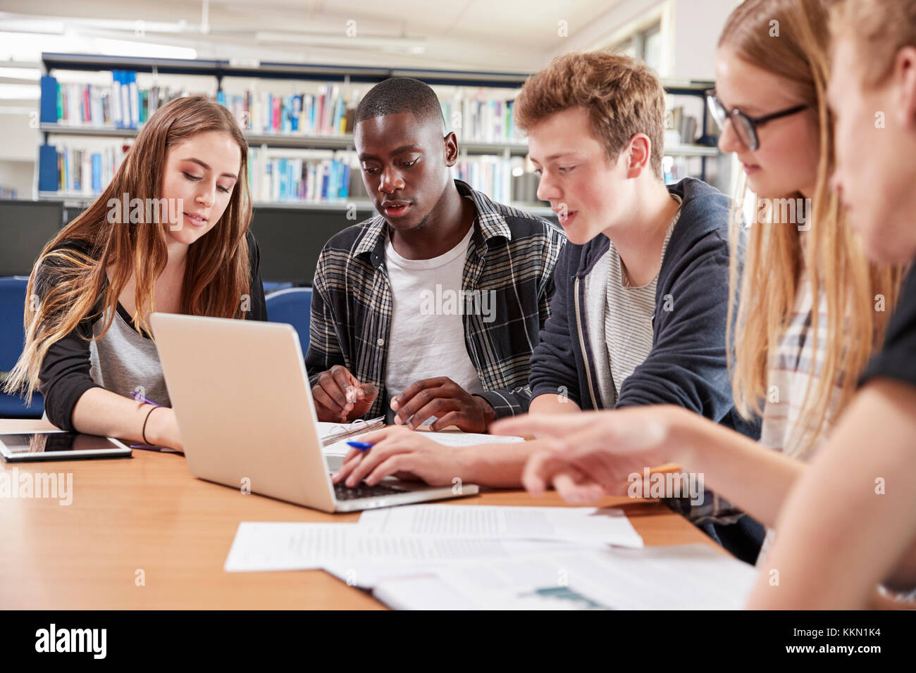Group Of College Students Collaborating On Project In Library Stock ...