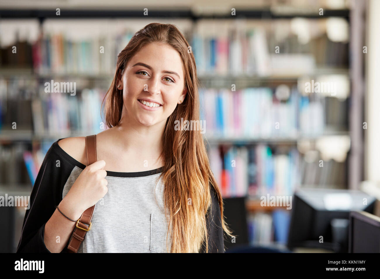 Portrait Of Female Student Standing In College Library Stock Photo - Alamy
