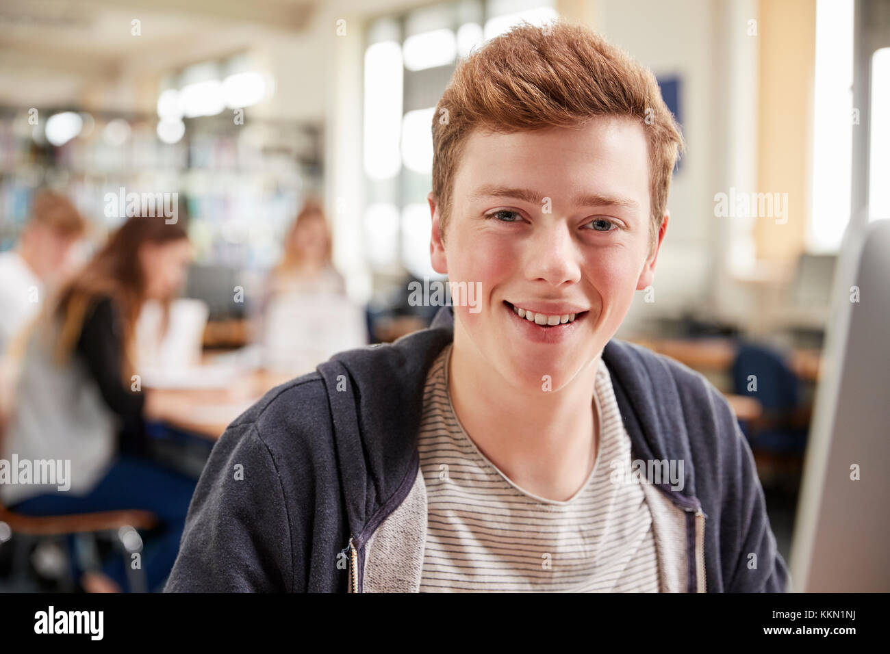 Portrait Of Male Student Working On Computer In College Library Stock ...