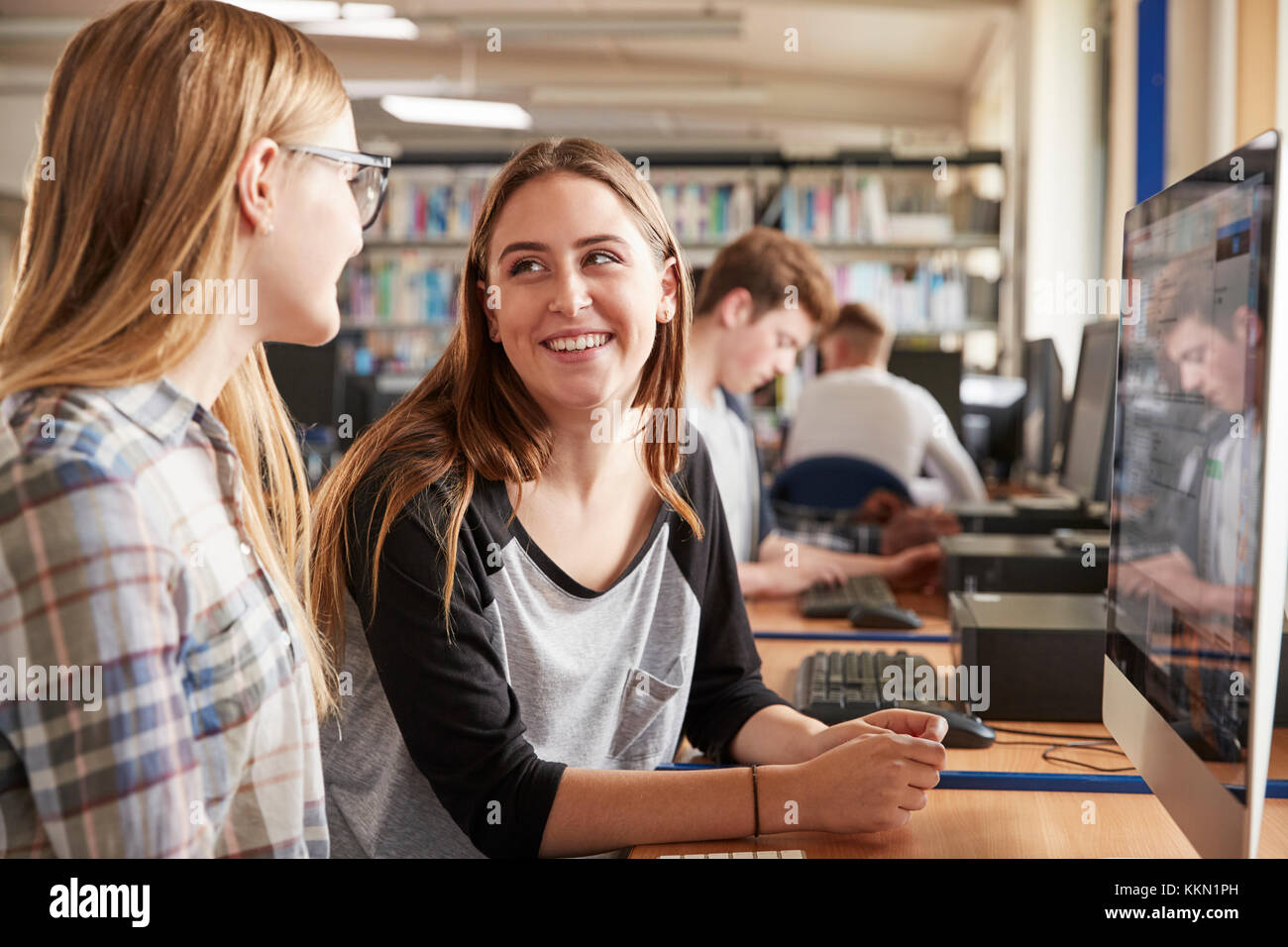 Two Female Students Working On Computer In College Library Stock Photo ...