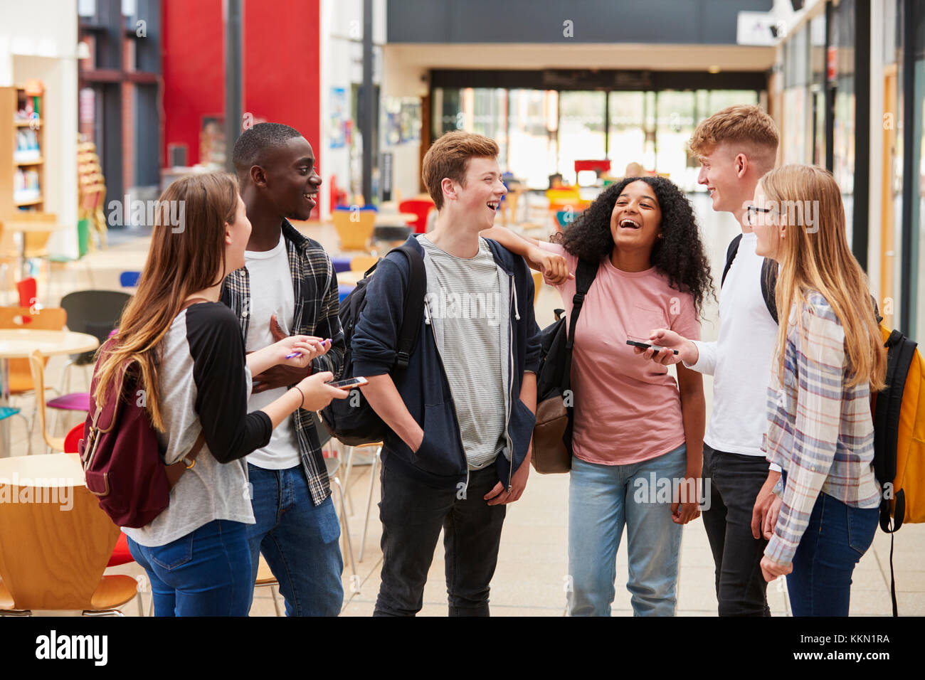 Student Group Socializing In Communal Area Of Busy College Stock Photo ...