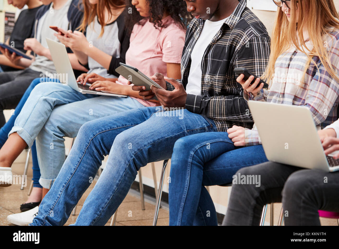 Close Up Of Seated College Students Using Digital Technology Stock ...