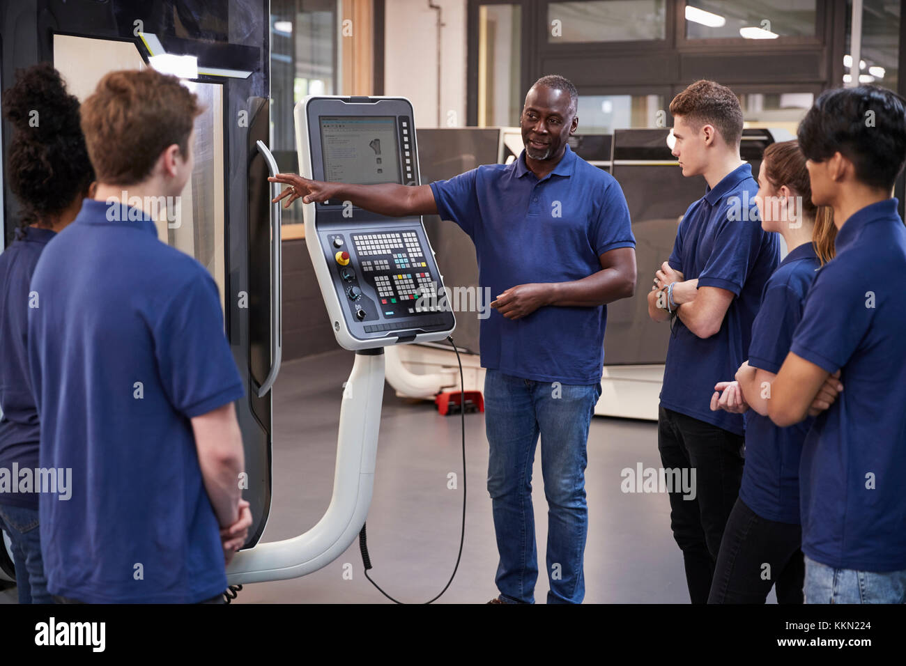 Engineer Showing Apprentices How To Use CNC Tool Making Machine Stock ...