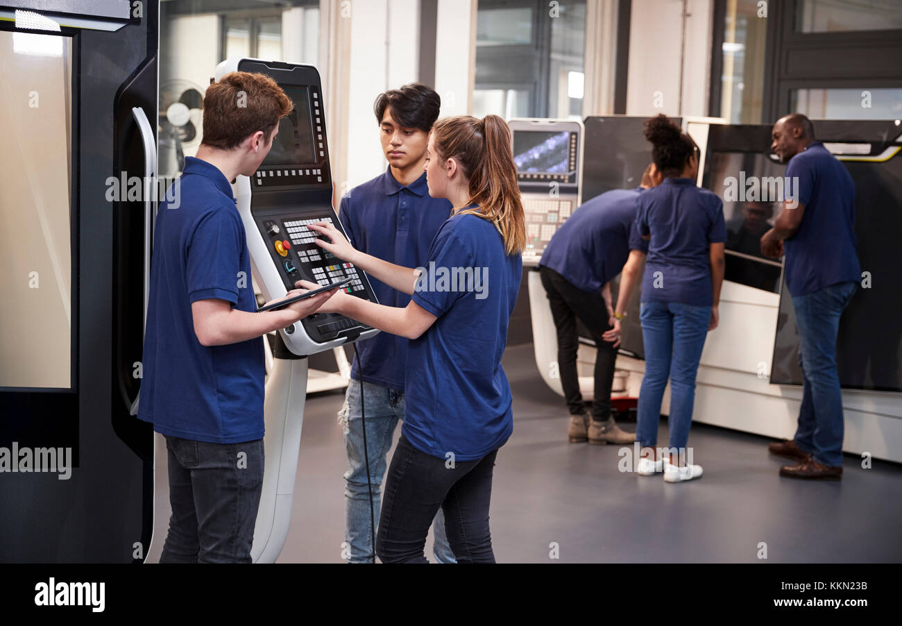 Engineer Showing Apprentices How To Use CNC Tool Making Machine Stock ...